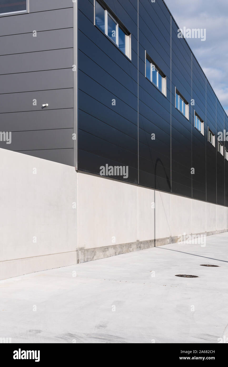 Industrial building facade with metallic cladding. Industrial warehouse ...