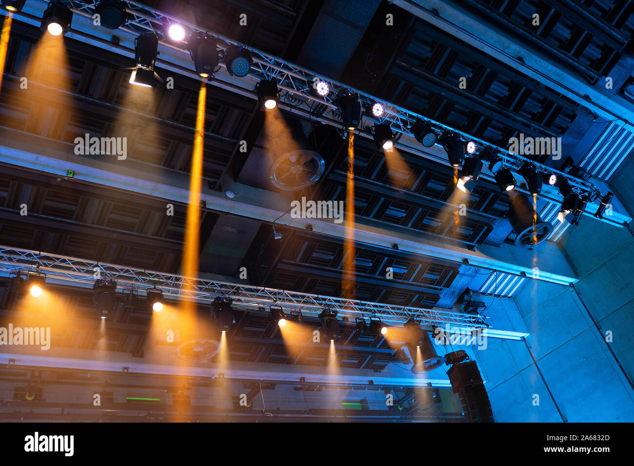 Stage lights. Orange and blue spot lights on steel construction ...