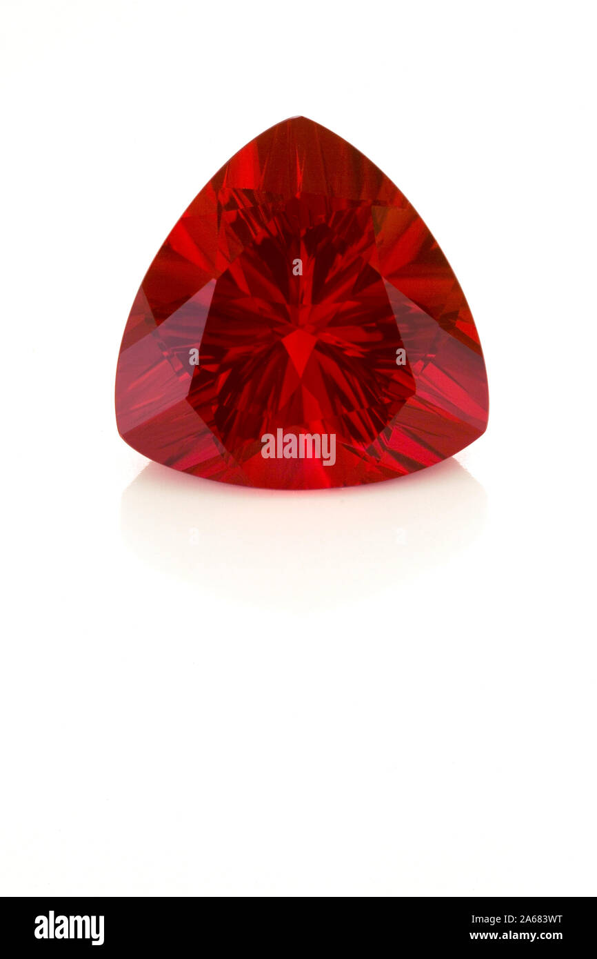 A large pincushion triangle faceted mexican fire opal shown on a white ...