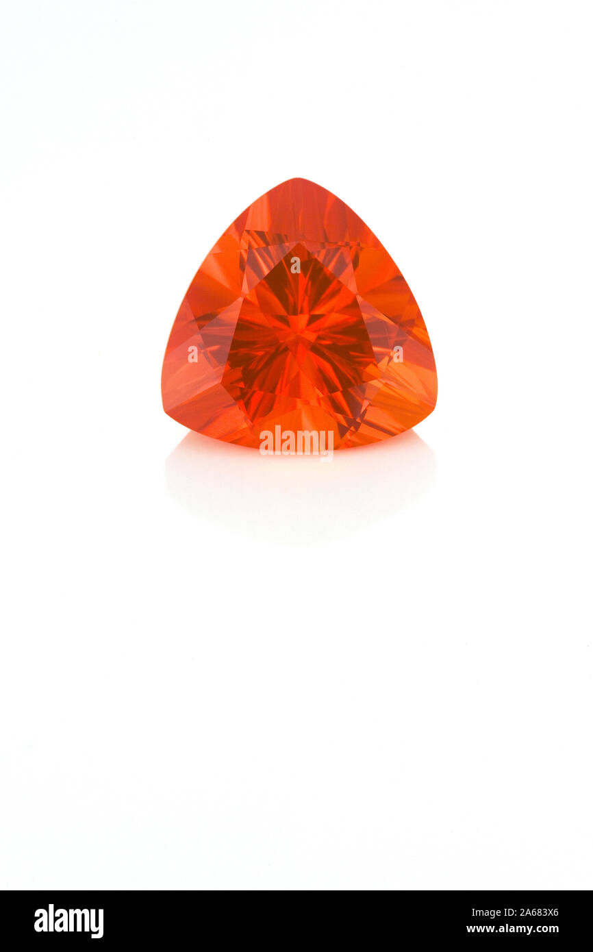 A large pincushion triangle faceted mexican fire opal shown on a white ...