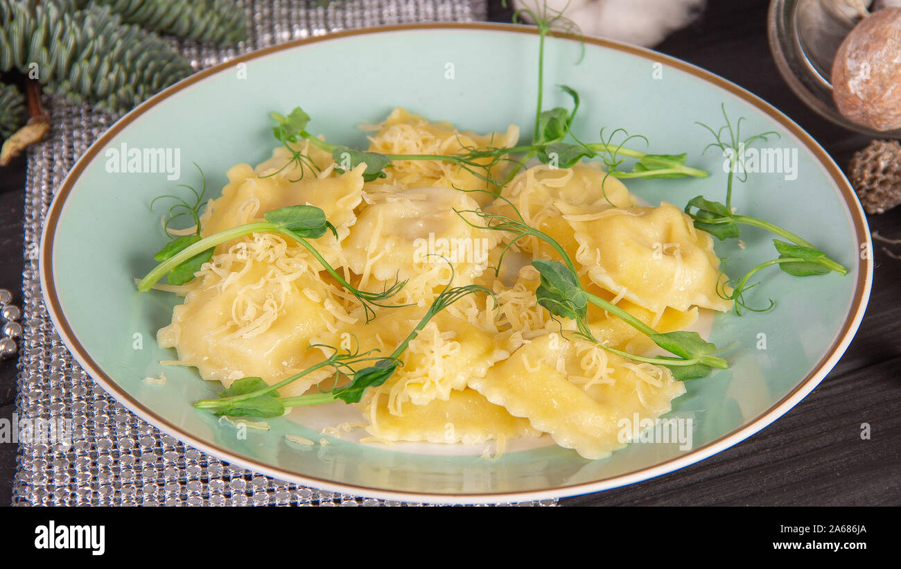 Italian ravioli with cheese and greenery on blue plate Stock Photo - Alamy