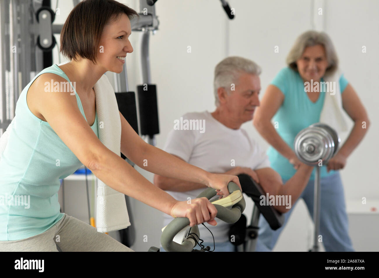 Portrait of active smiling people exercising in gym Stock Photo - Alamy