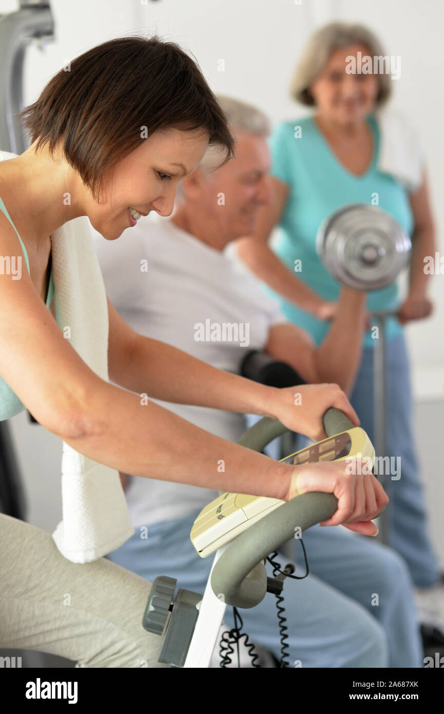 Portrait of active smiling people exercising in gym Stock Photo - Alamy