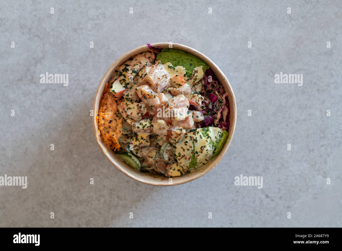 California Poke Bowl with salmon, avocado, crab surimi, carrot, red ...