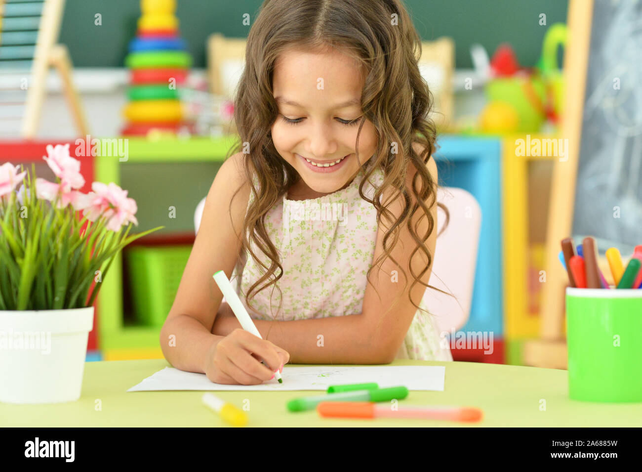 Close up portrait of cute smiling girl drawing Stock Photo - Alamy