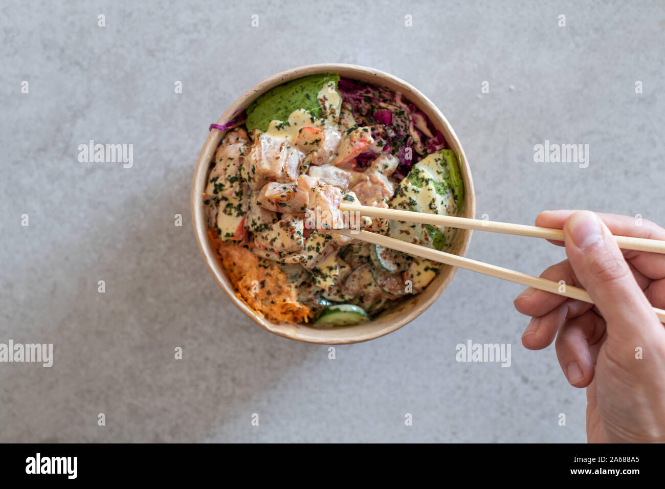 California Poke Bowl with salmon, avocado, crab surimi, carrot, red ...