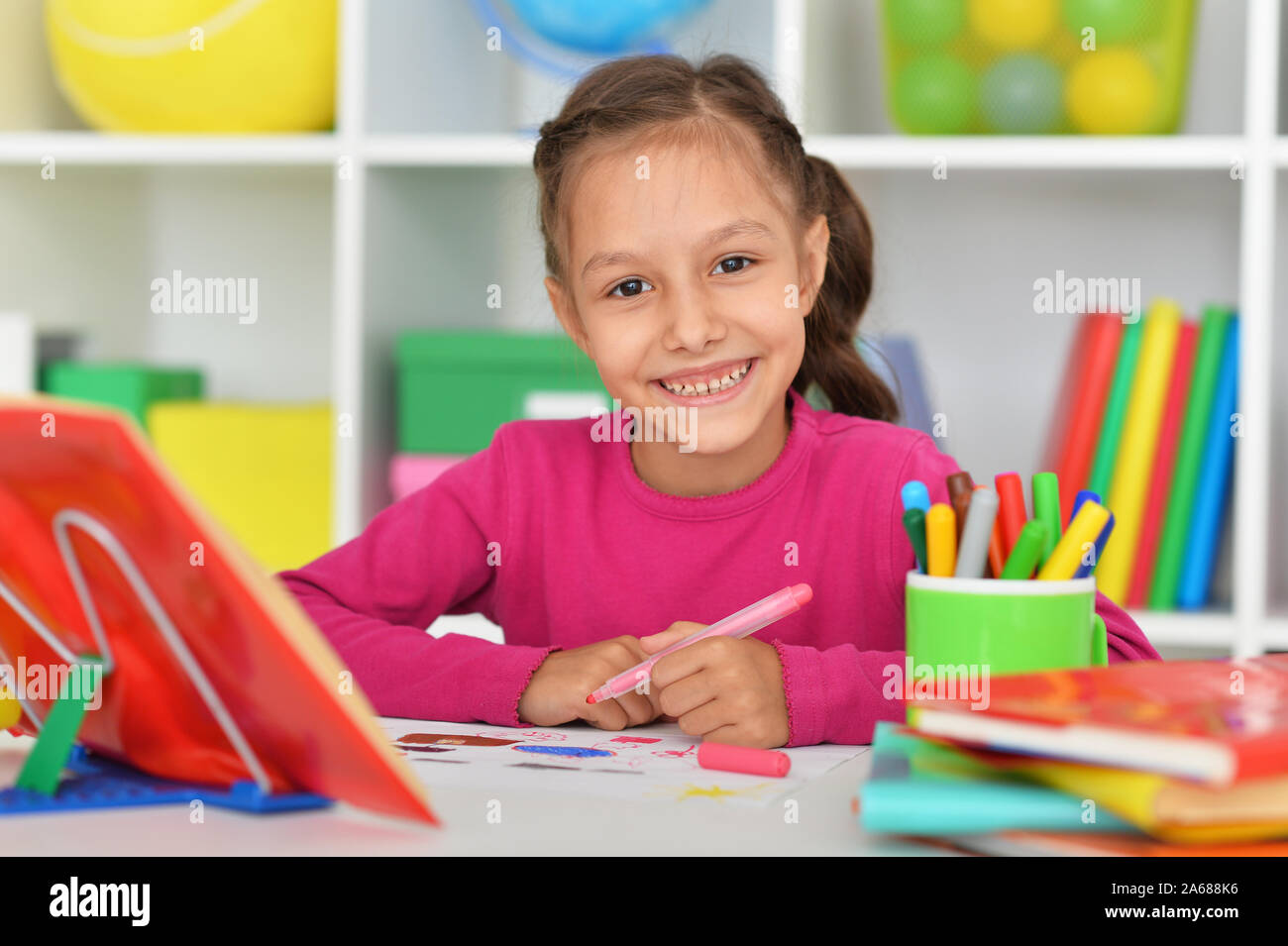 Close up portrait of cute smiling girl drawing Stock Photo - Alamy