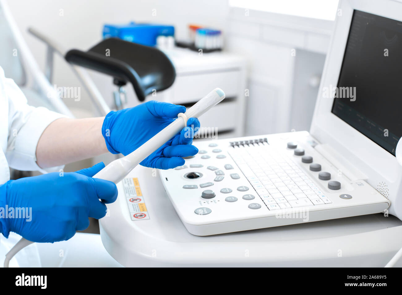 gynecologist doctor prepares an ultrasound machine for the diagnosis of ...
