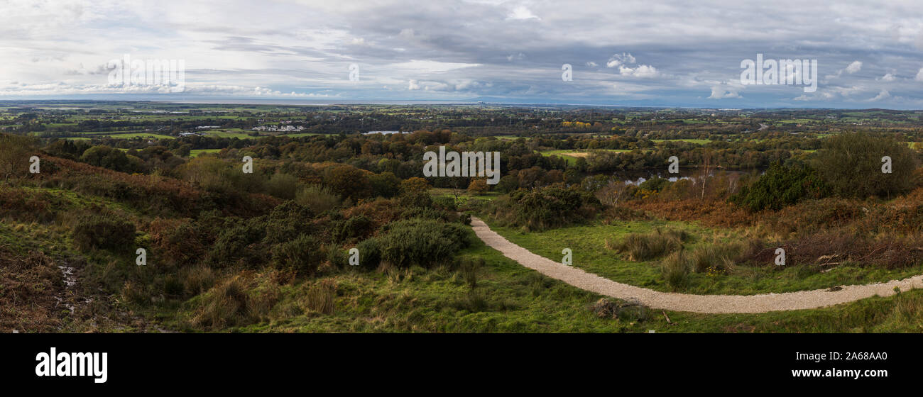 A pathway slopes and curves from the summit of Nicky Nook Trig Point ...