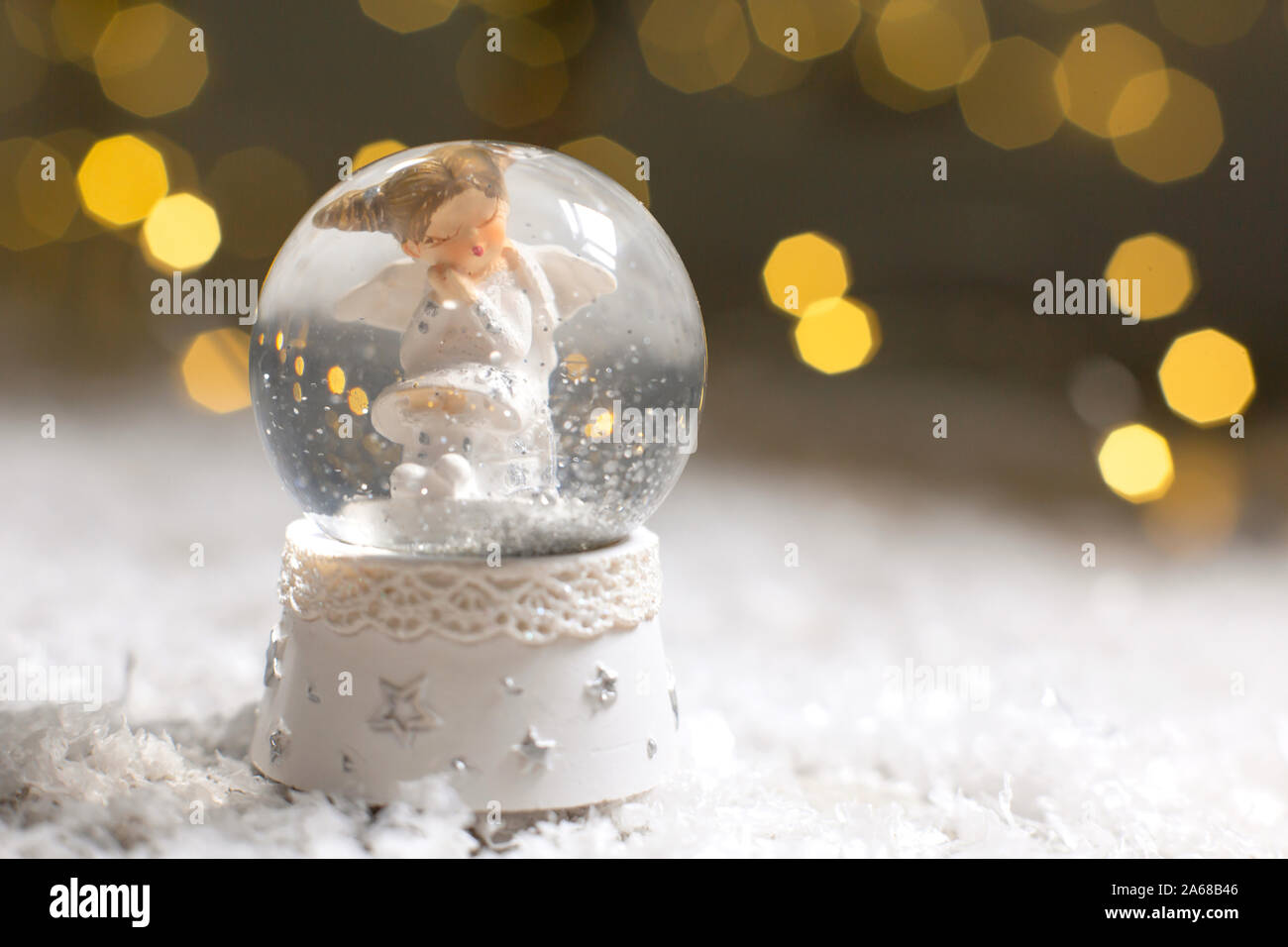 Decorative Christmas-themed figurines. Glass ball with snowflakes in ...