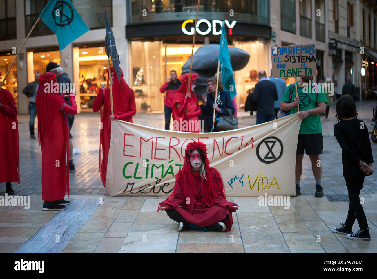 An extinction rebellion activist meditating on the street during the ...