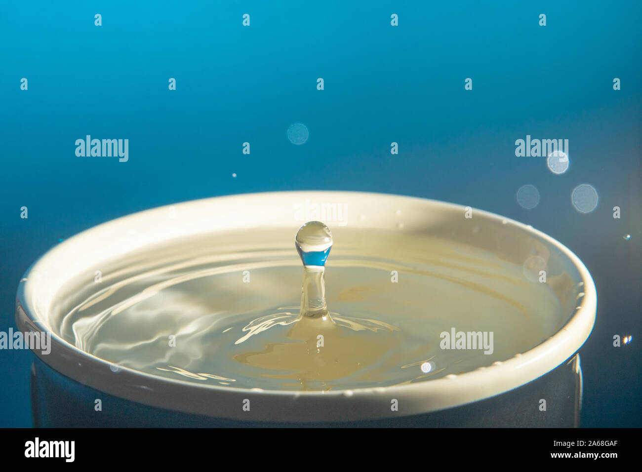 Drop of water falling into a glass, hitting water surface.Selected ...