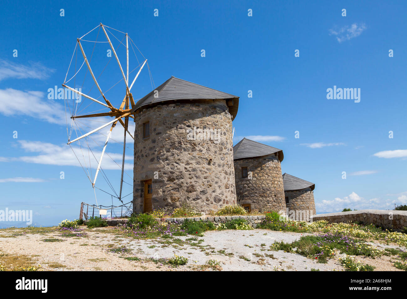 Three restored stone,windmills on top of a hill. These are on the Geeek ...