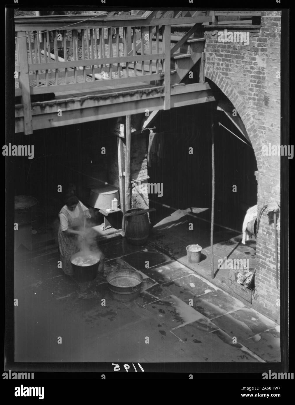 Woman doing laundry in a courtyard, New Orleans Stock Photo - Alamy