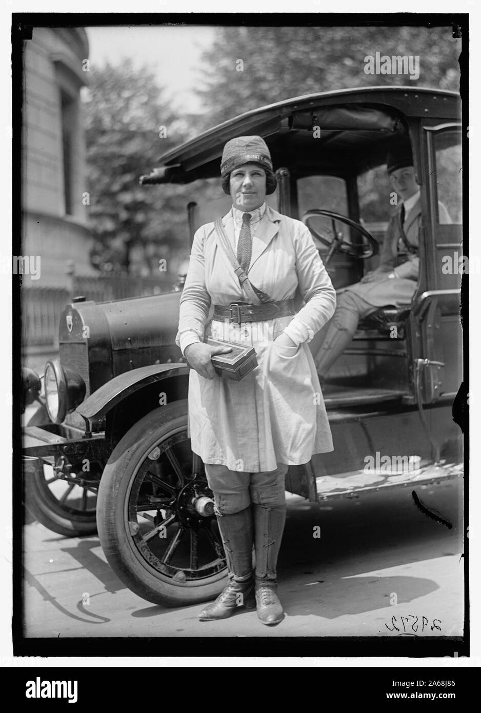 Woman in uniform wearing hat with label: War Camp Community Service ...