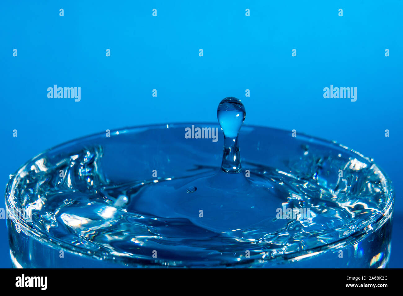 Drop of water falling into a glass, hitting water surface.Selected ...