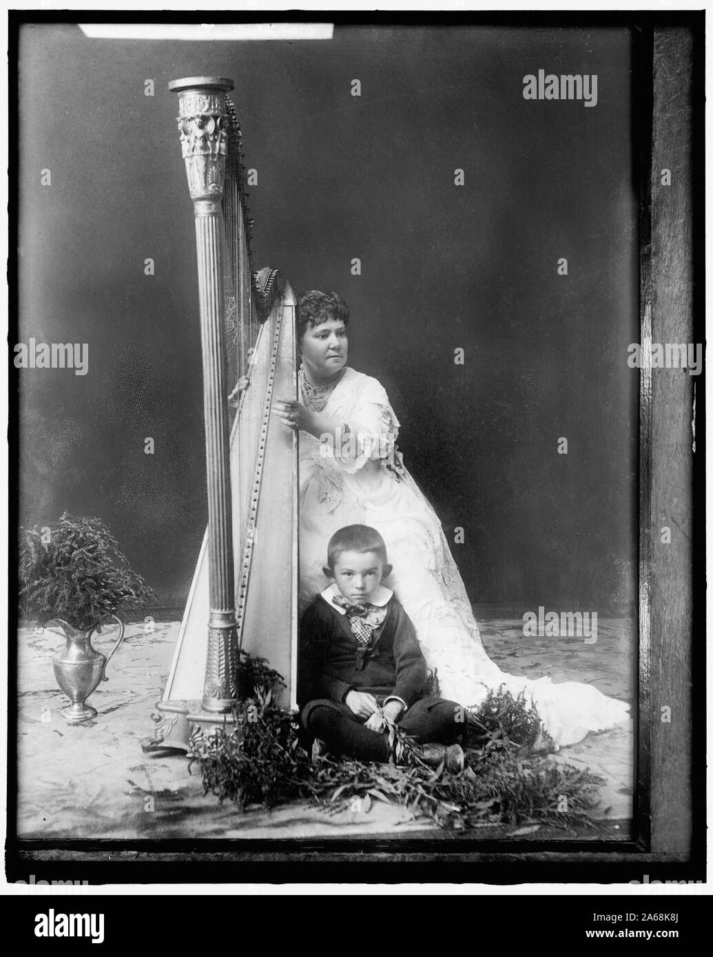 Woman with harp and boy Stock Photo - Alamy