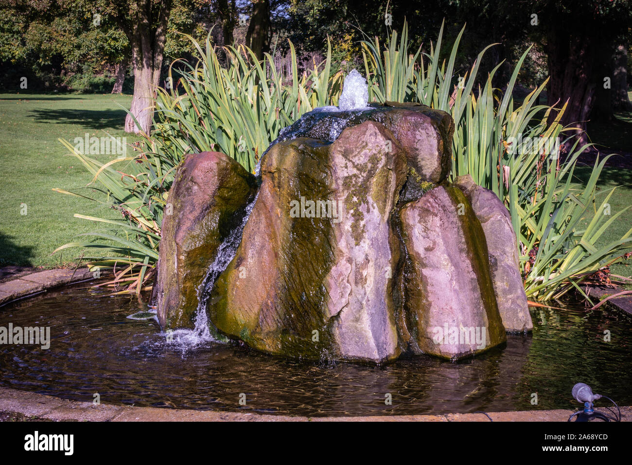Natural rock water feature fountain Stock Photo - Alamy
