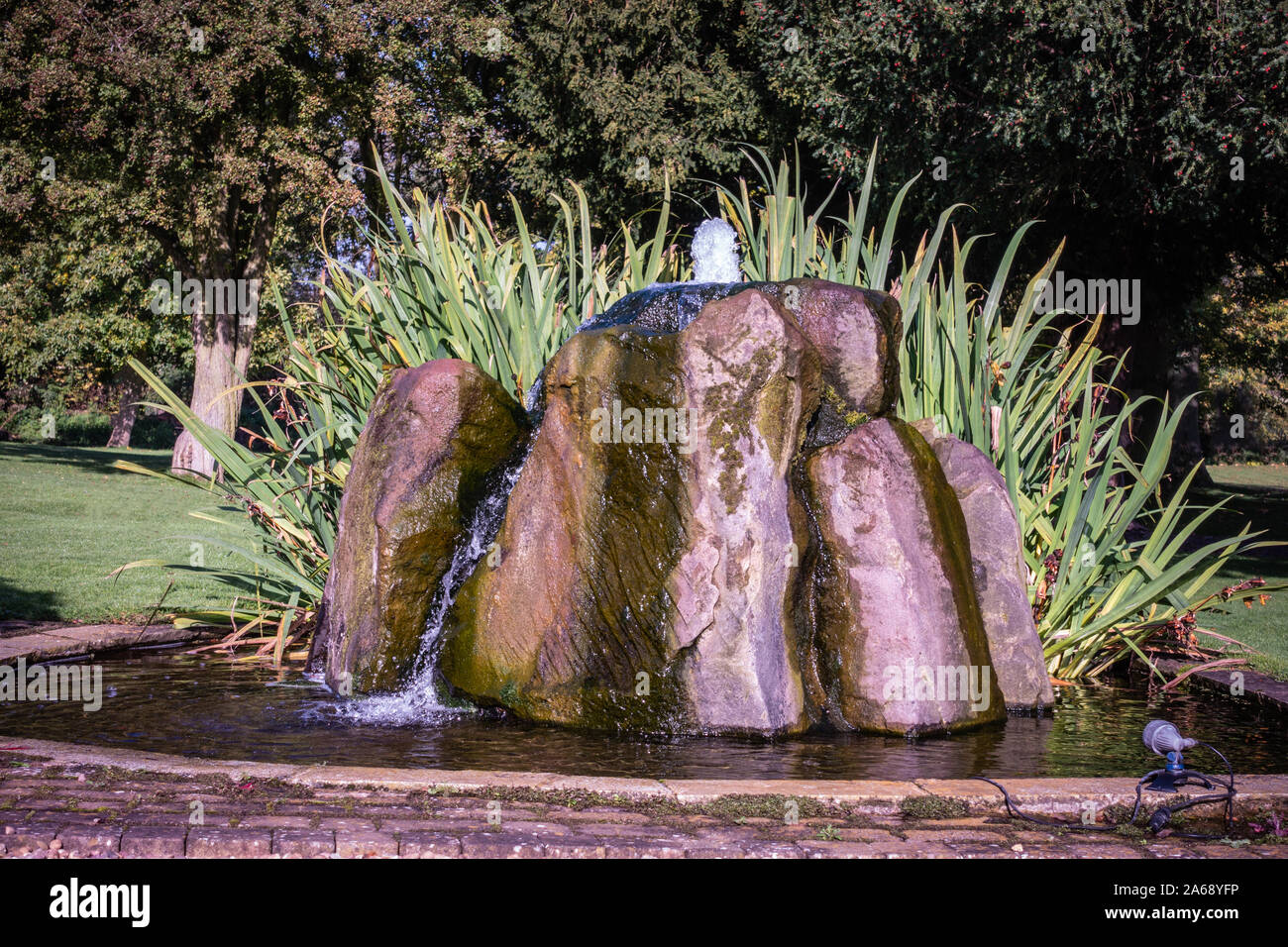 Natural rock water feature fountain Stock Photo - Alamy