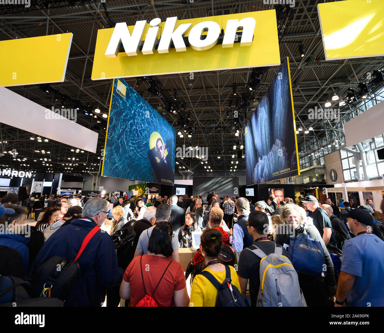 Customers are seen at the Nikon booth during the PhotoPlus Expo ...