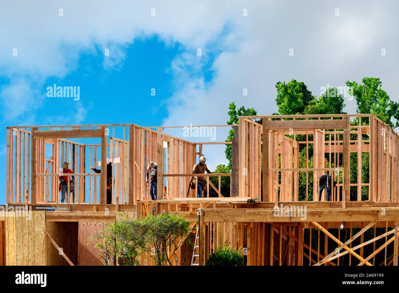 Construction workers building a two story residential house Stock Photo ...