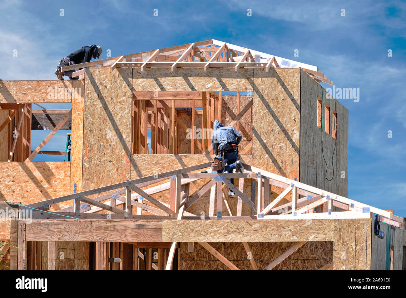 Construction workers building a two story residential house Stock Photo ...
