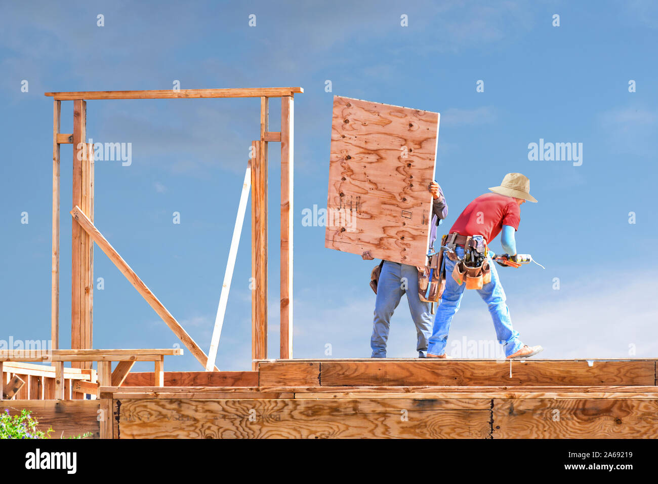 Construction workers building a two story residential house Stock Photo ...
