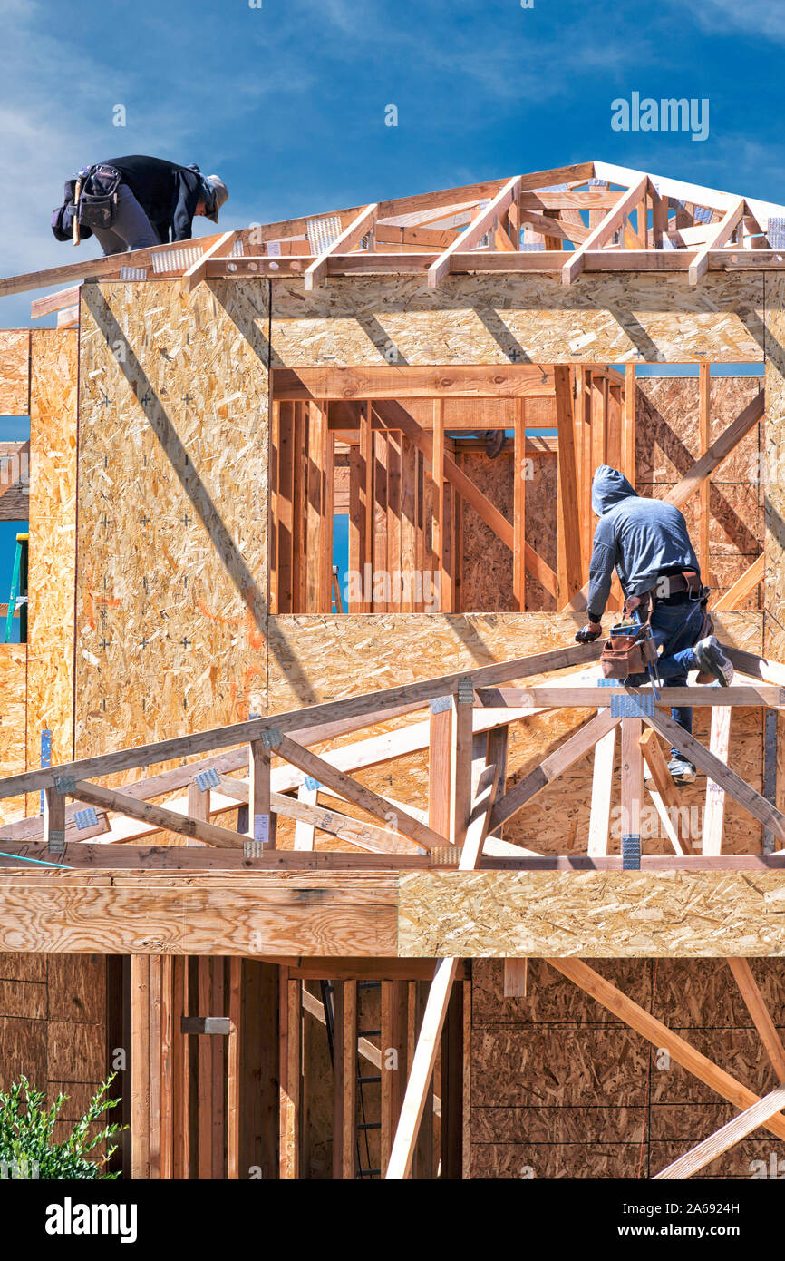 Construction workers building a two story residential house Stock Photo ...
