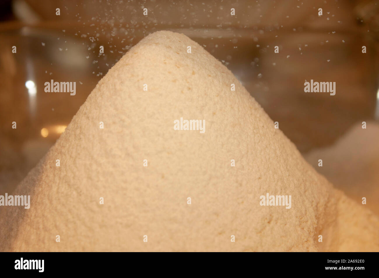 Cloud of sifted almond flour in the form of rain falling to flour ...