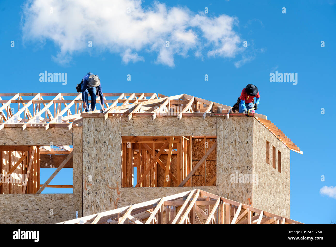 Construction workers building a two story residential house Stock Photo ...