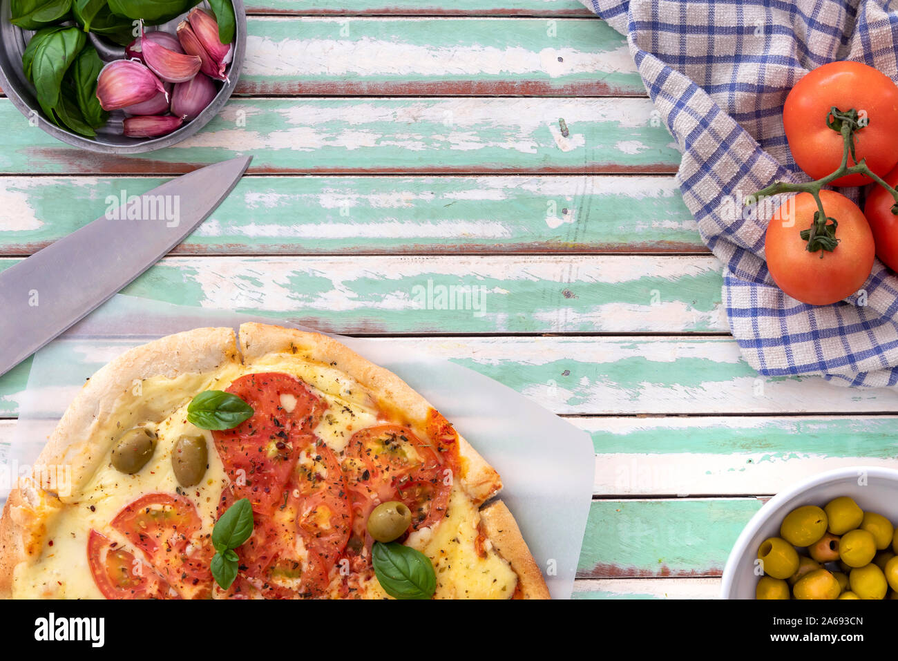 Freshly made wood fired pizza viewed from above on rustic turquoise ...