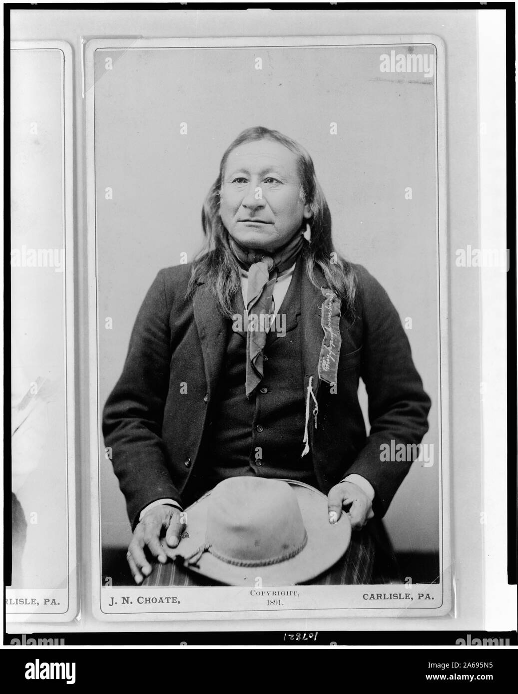 Man seated holding hat facing left Cut Out Stock Images & Pictures - Alamy