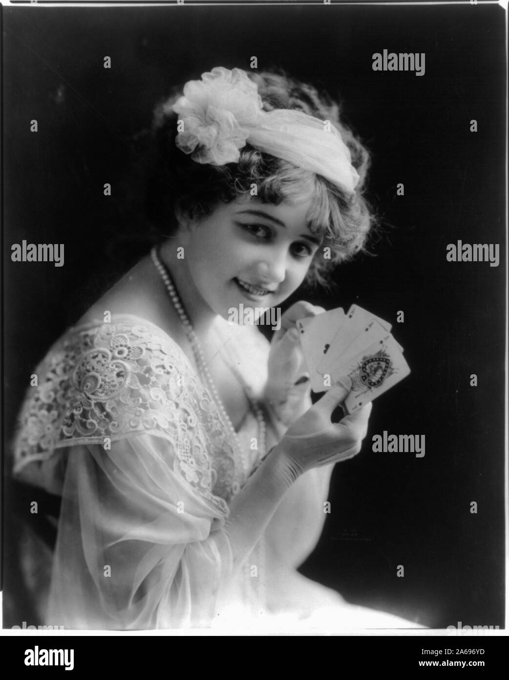 Young woman, half-length portrait, seated, facing front, wearing lace ...