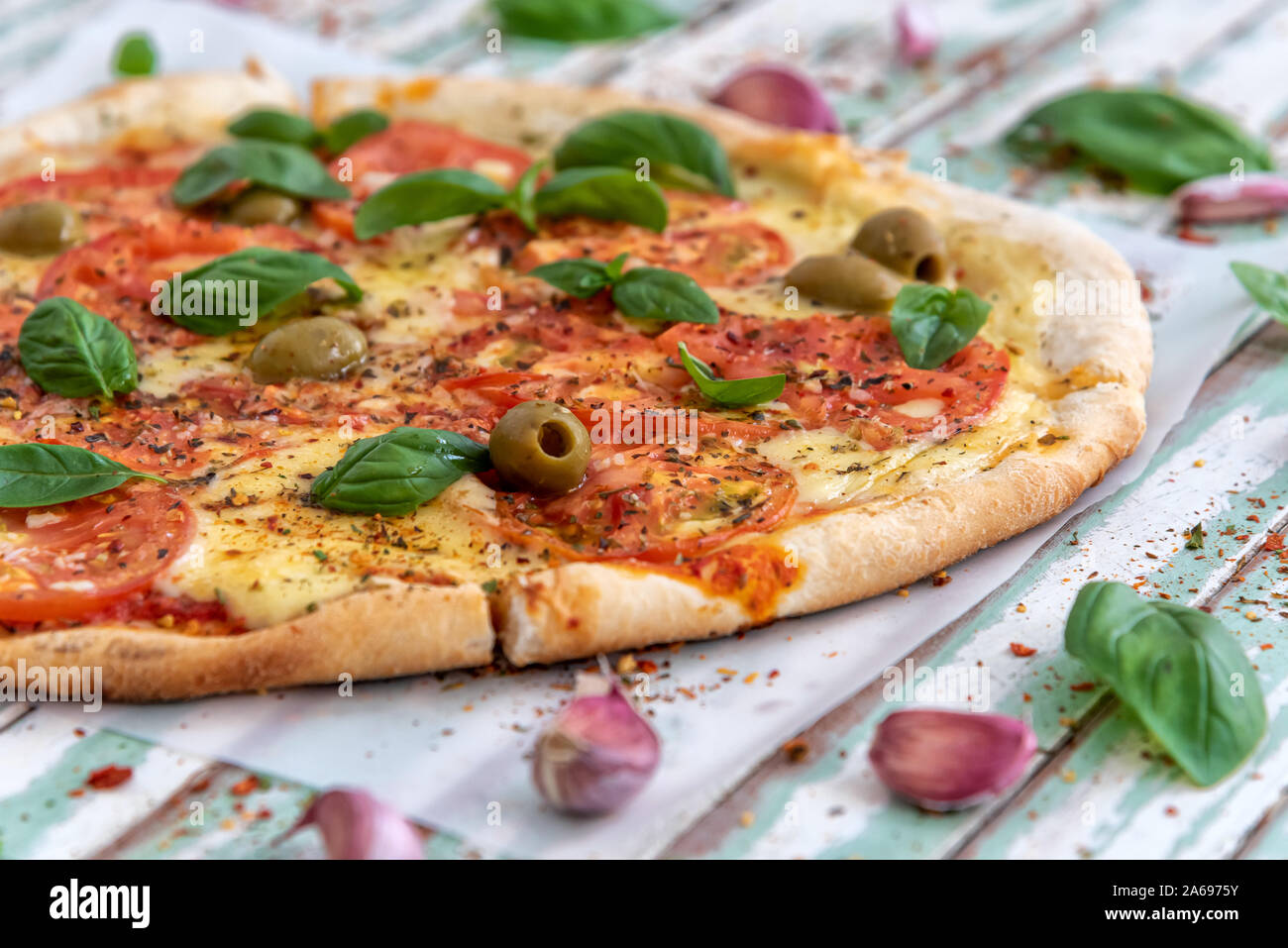 Freshly made wood fired pizza viewed from above on rustic turquoise ...