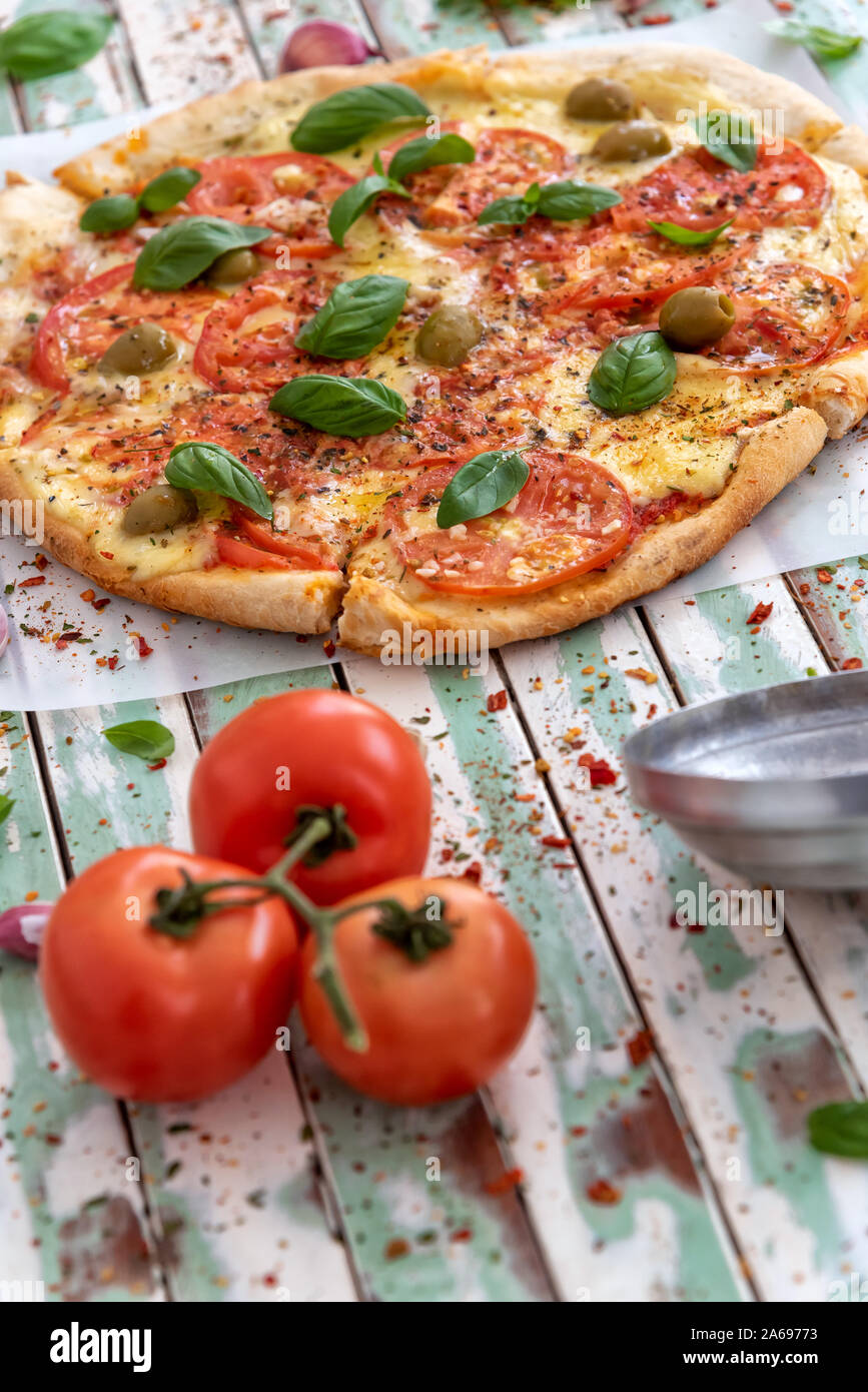 Freshly made wood fired pizza viewed from above on rustic turquoise ...