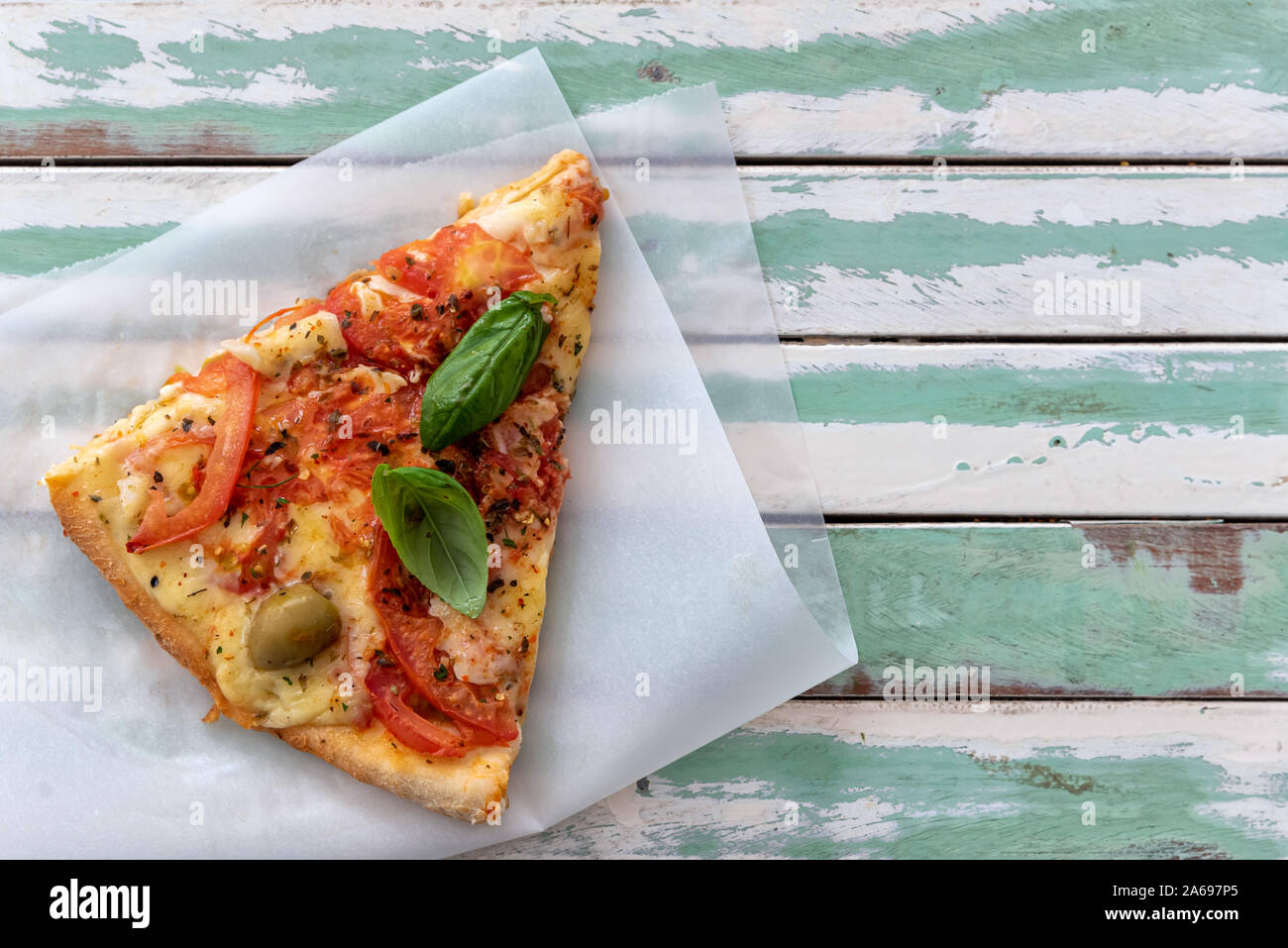 Freshly made wood fired pizza viewed from above on rustic turquoise ...