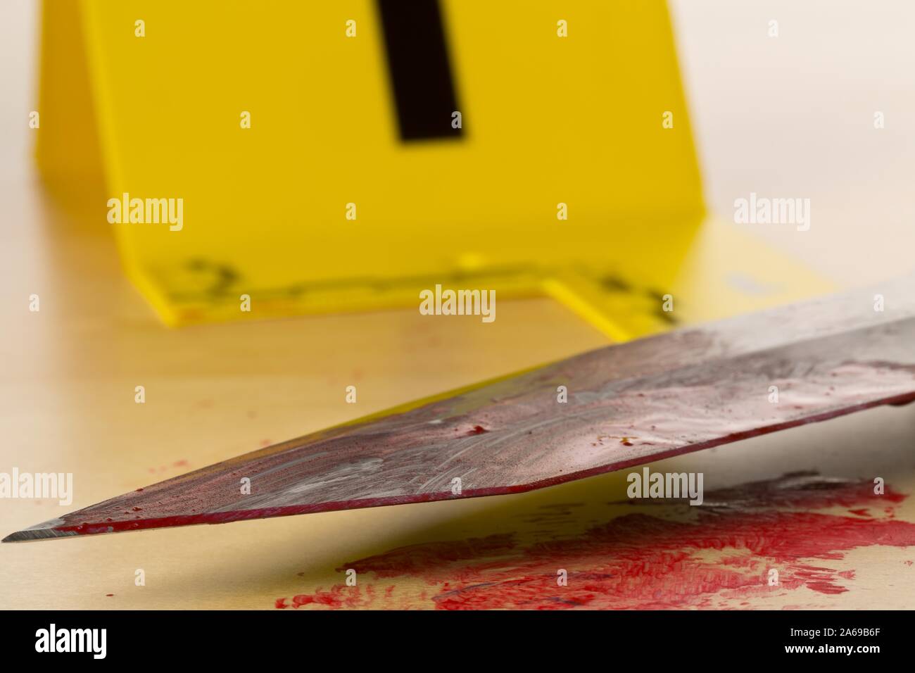 Crime scene investigation CSI evidence marker with bloody knife on ...