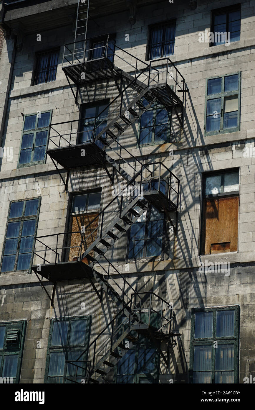 Exterior Metal Stairs with Shadows on old abandoned building in old ...