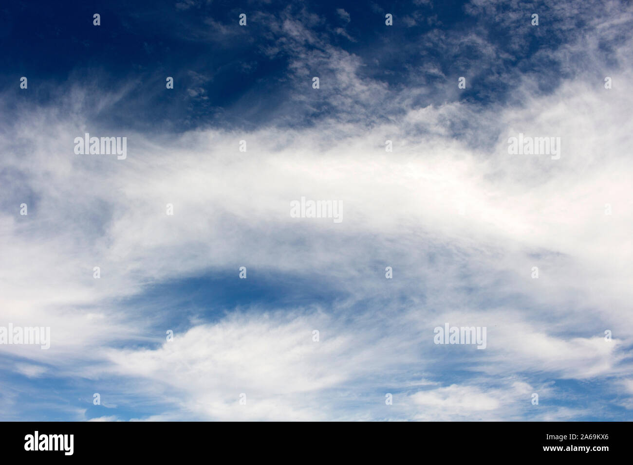 High white wispy cirrus clouds with cirro-stratus in the blue ...