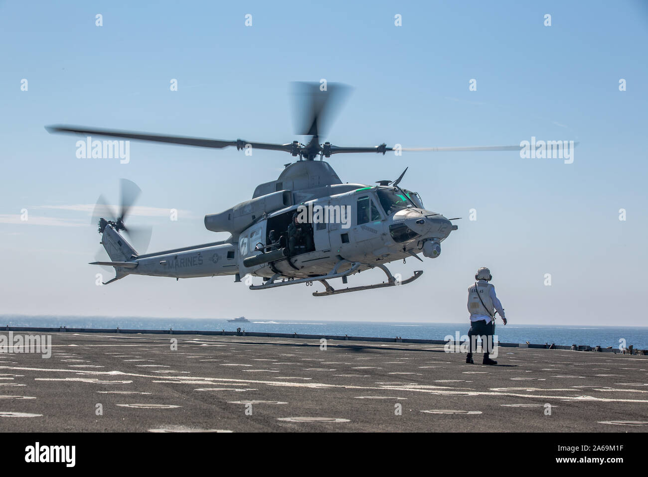 U.S. Sailors assigned to the USS Comstock (LSD-45), radio commands to a ...