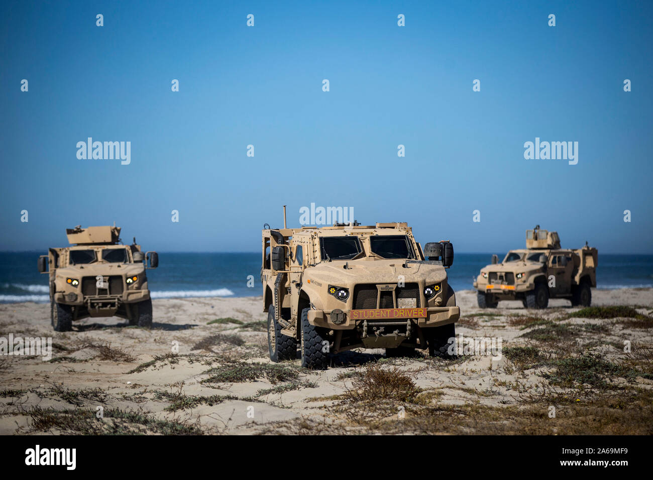 U.S. Marines drive Joint Light Tactical Vehicles at White Beach as part ...