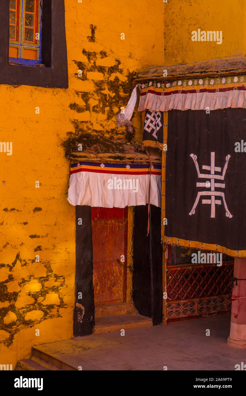 A shambu or ruffled banner hangs over a doorway in the colorful Serdung ...