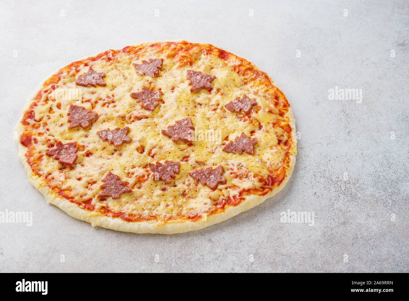 Pepperoni pizza decorated with fir-trees for a Christmas dinner. Food ...