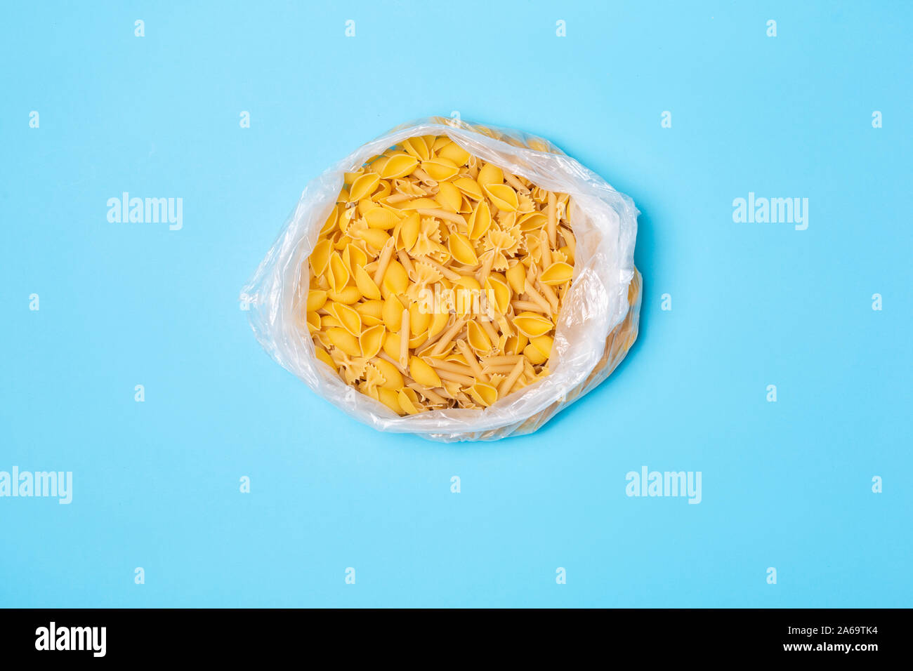 Pasta macaroni in plastic bag isolated on blue top view Stock Photo - Alamy