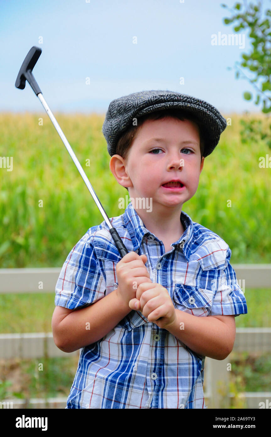 A cute little boy playing golf at home in the back yard Stock Photo - Alamy