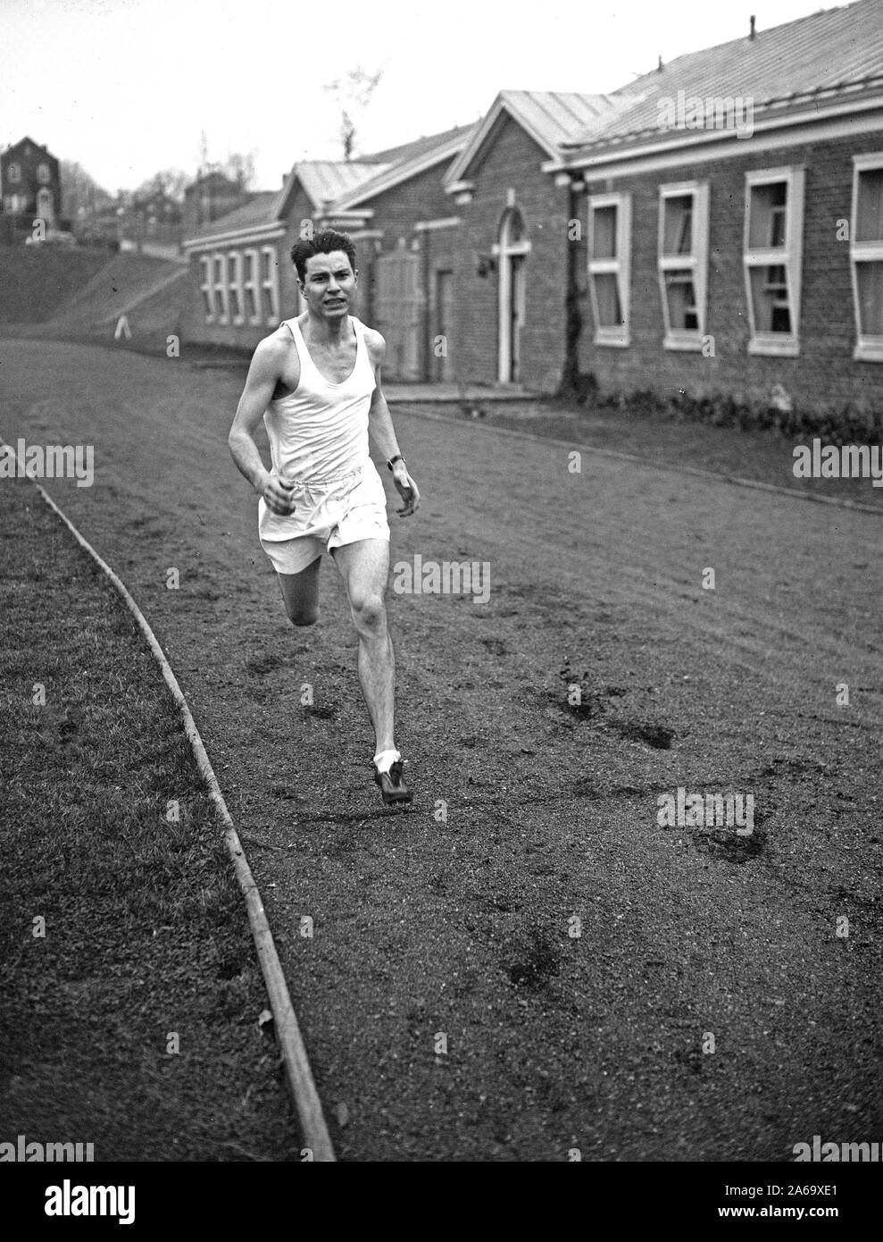 Man running on a track ca. 1936 Stock Photo - Alamy