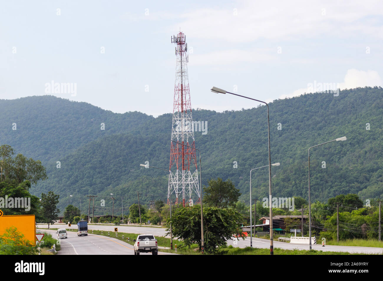 Telecommunications tower on main road with mountain background Stock ...