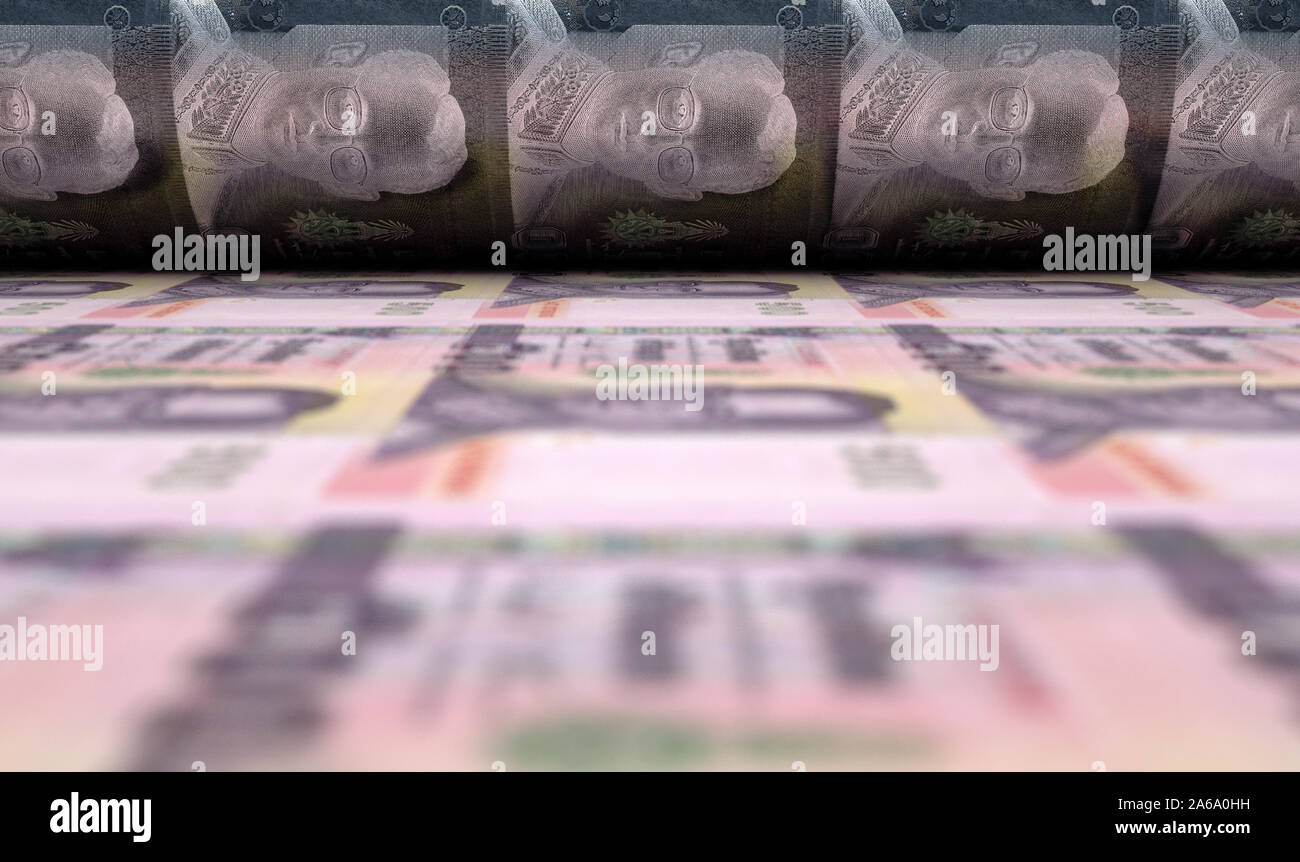 A concept image showing a sheet of Thailand Bhat notes going through a ...
