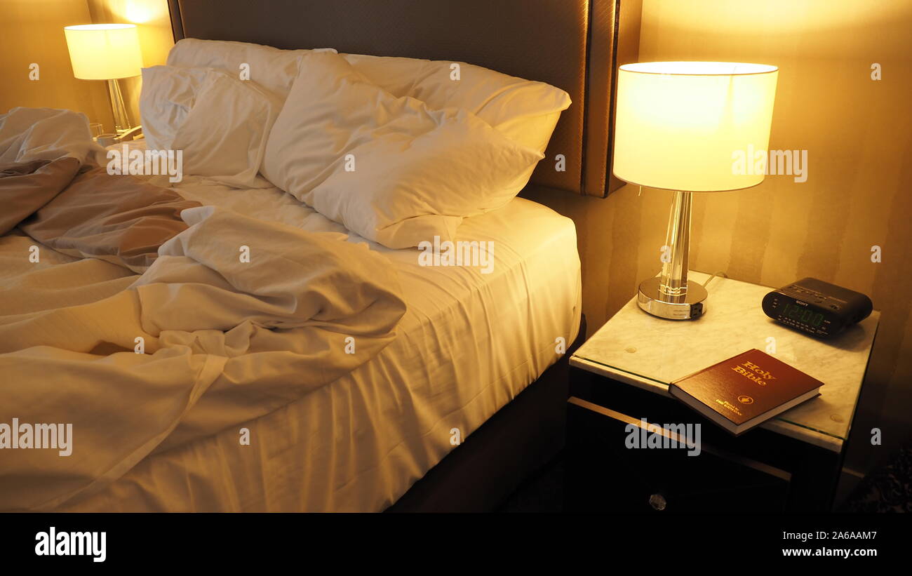 Warm hotel room with bedside bible hi-res stock photography and images ...