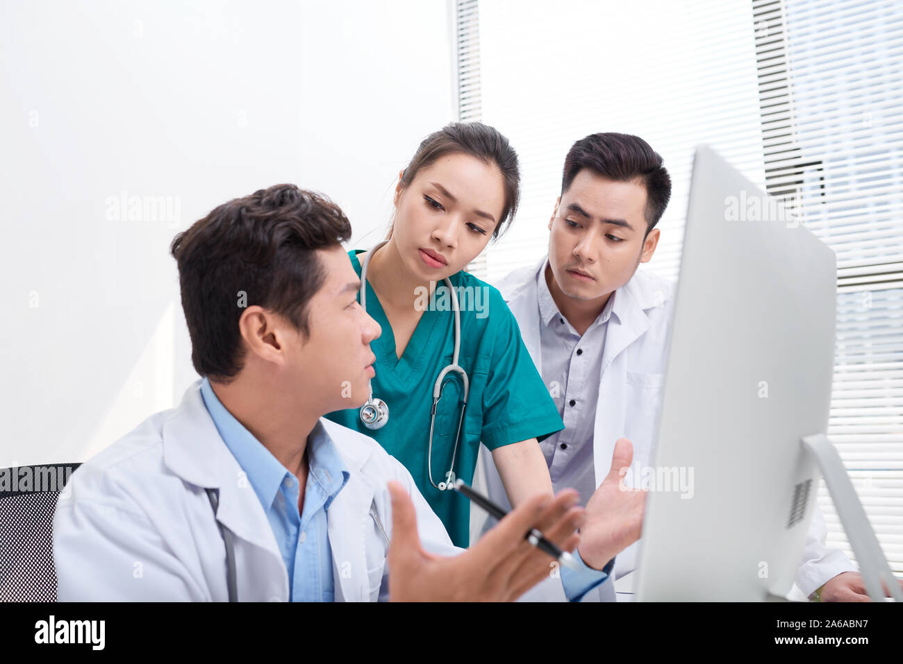 Team of doctors working and having on laptop in medical office Stock ...